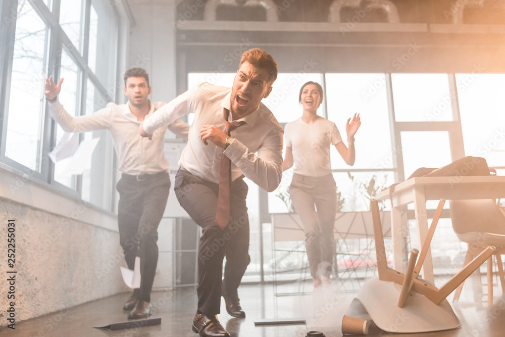 scared businesspeople running and screaming in office with smoke Stock ...