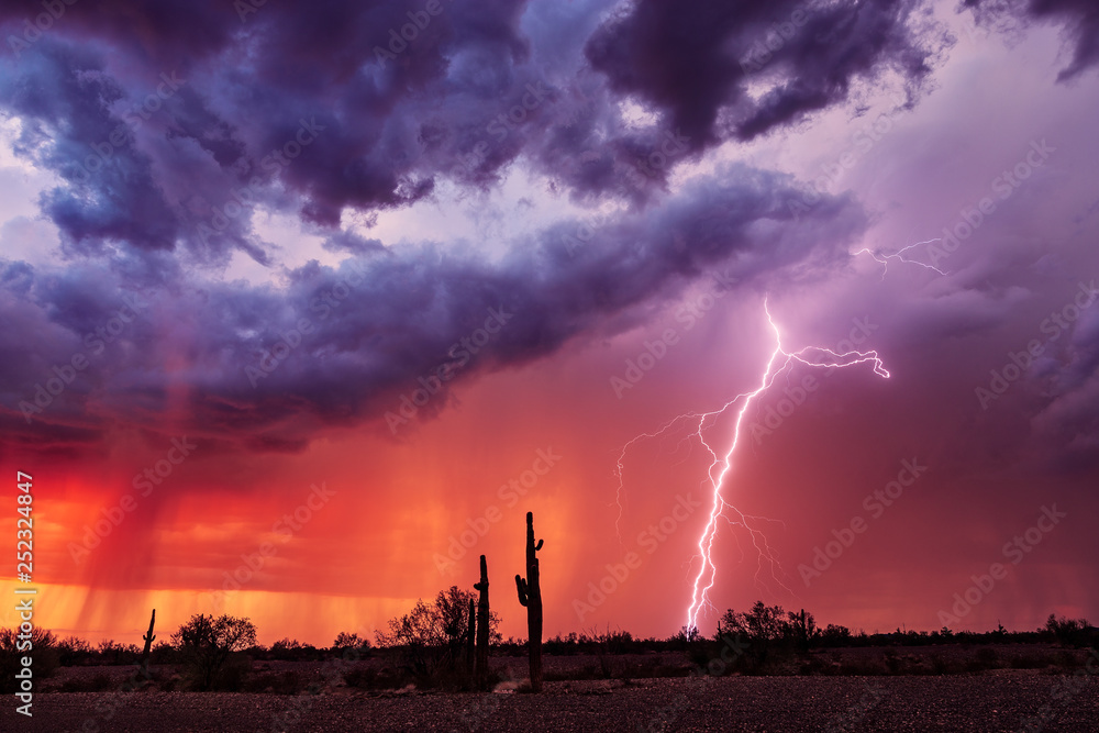 Lightning bolt strikes from a storm at sunset. Stock Photo | Adobe Stock