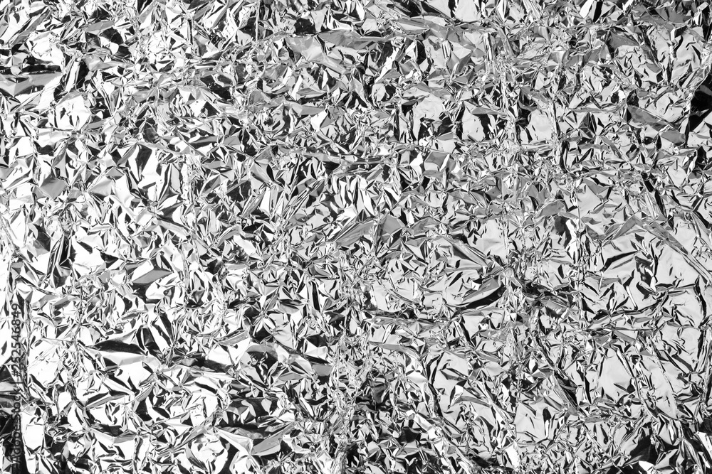 Crumpled silver foil shining texture background, bright shiny festive ...
