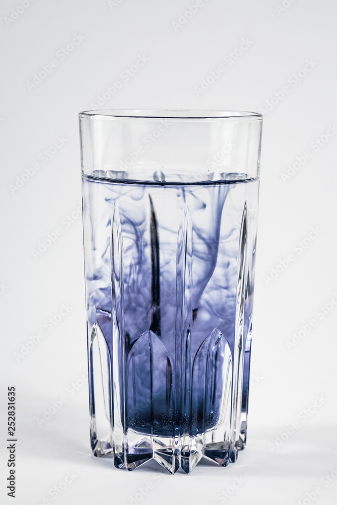 Water pollution concept. Dark substance mixing with clean water in a ...