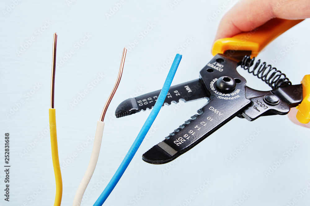 Electrician uses wire stripper cutter during electrical wiring s Stock ...