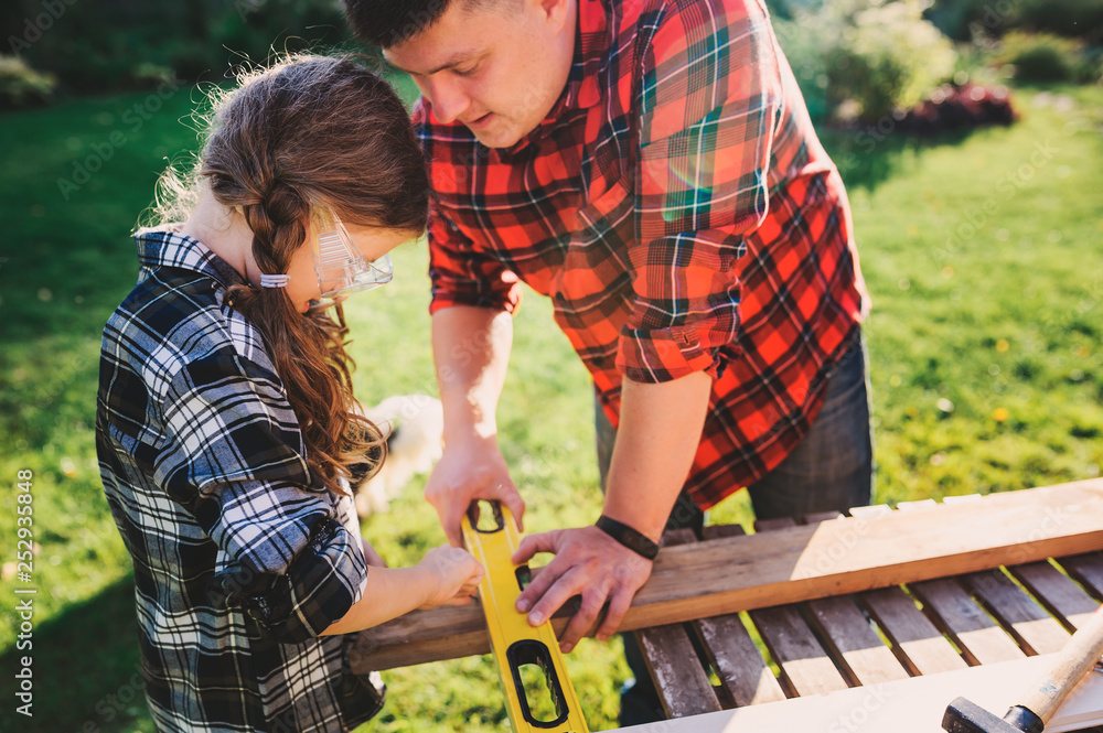 father teaching kid daughter to use tools. Girl helping dad with ...