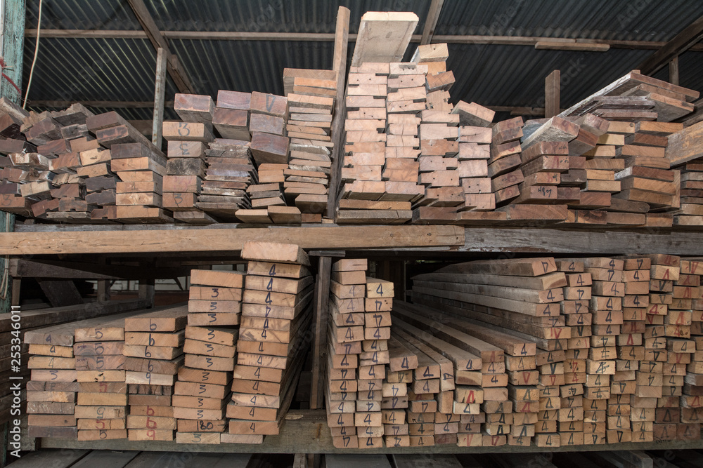 Piles of old wooden boards in the sawmill, Warehouse for sawing boards ...
