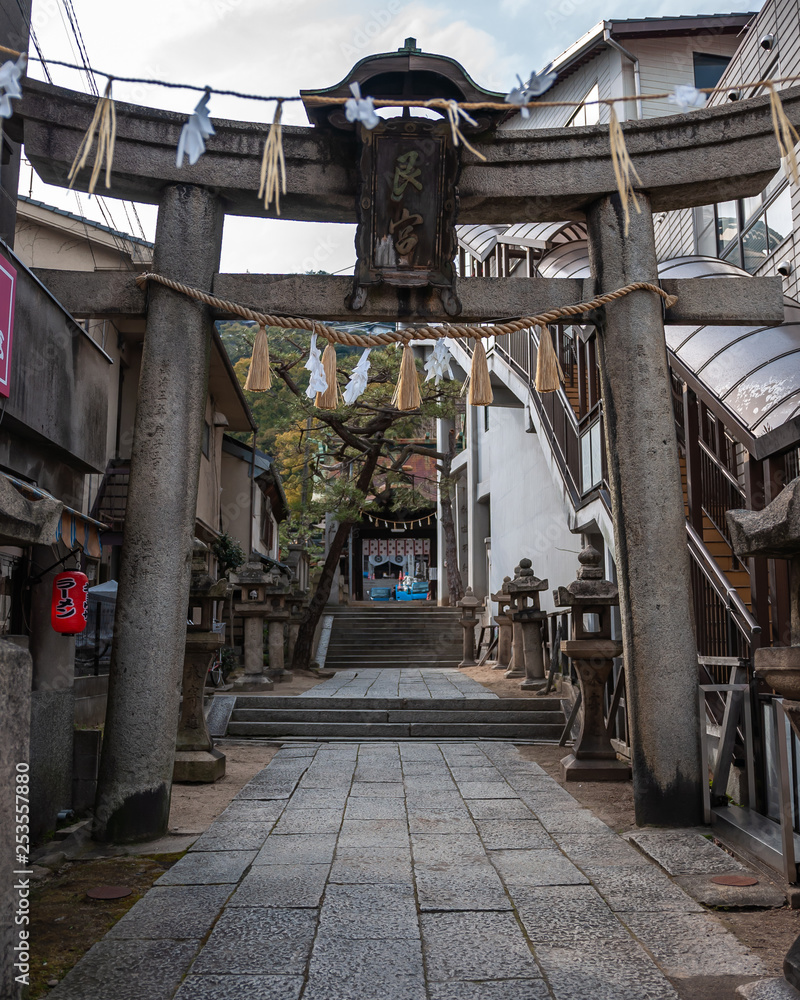 Photo Stock Ancient torii gate leading to Ushitora Shrine, with a ...