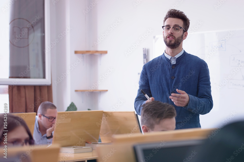 Group of students study with professor in modern school classroom. Male ...