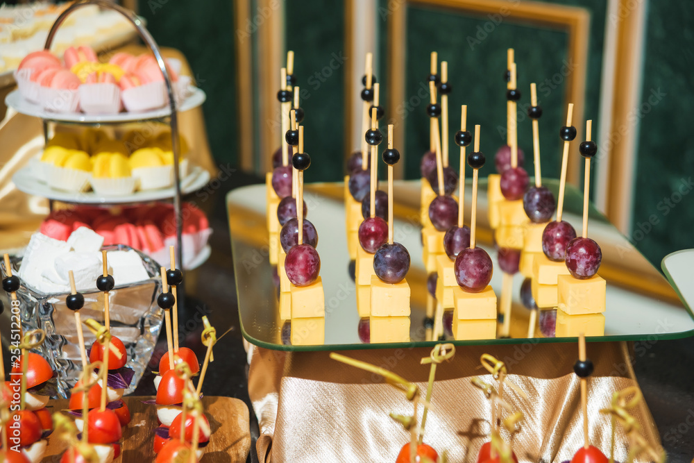 Festive table setting. Furshet. Canape. Snacks on sticks. Little ...