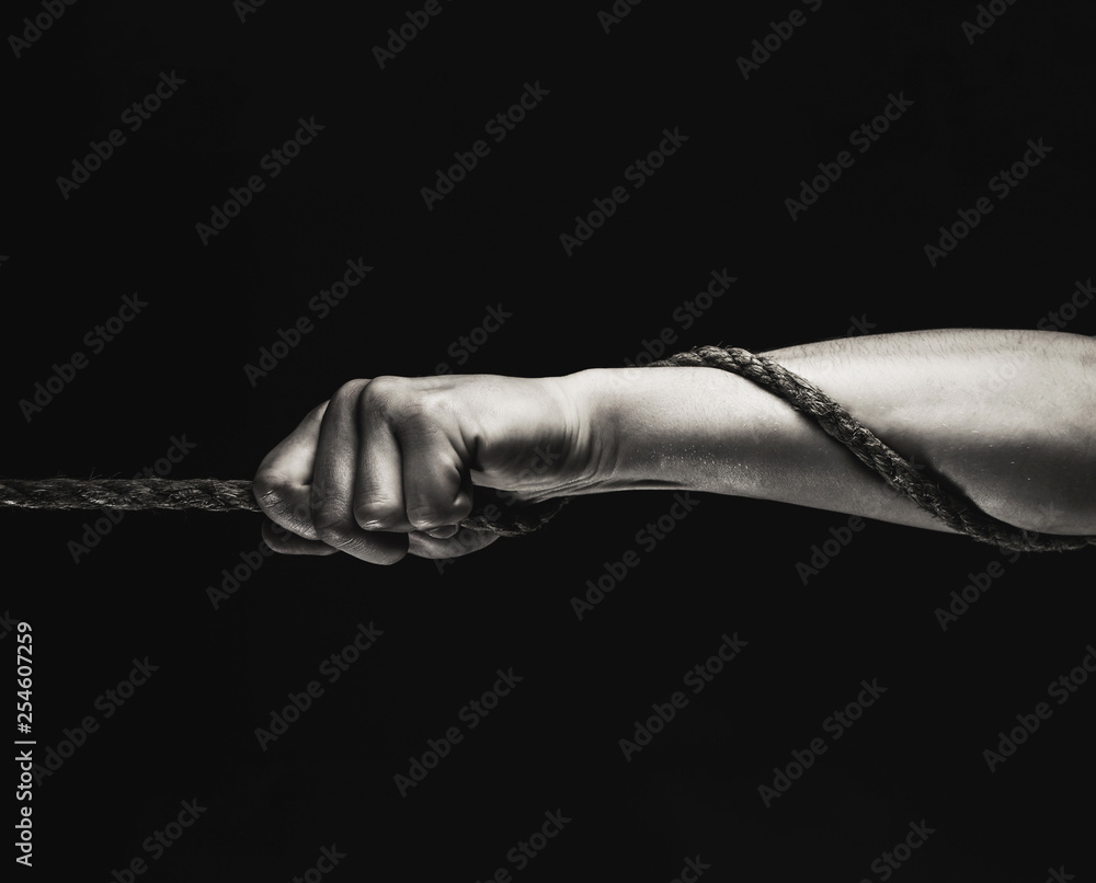 Man's hand holding on to the rope. Hand holding a rope, climbing rope, strength and ...