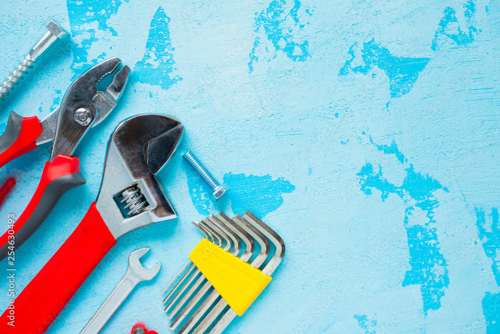 Construction tooling on the blue stone background. Hammers, screws, saw ...