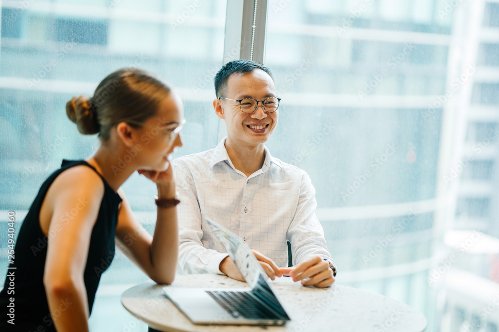 A young Asian Chinese pro is giving a presentation before his ...
