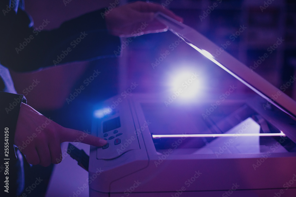 Copier scanner with a bright light inside. Office hazards concept ...