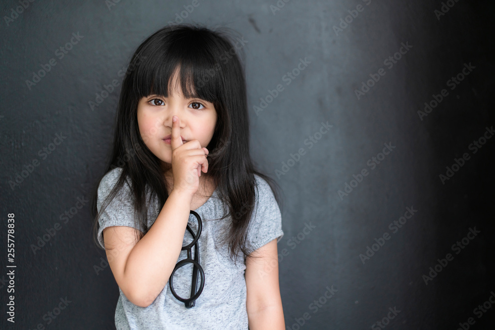pretty caucasian girl kid fun and naughty pose photo shoot black wall ...