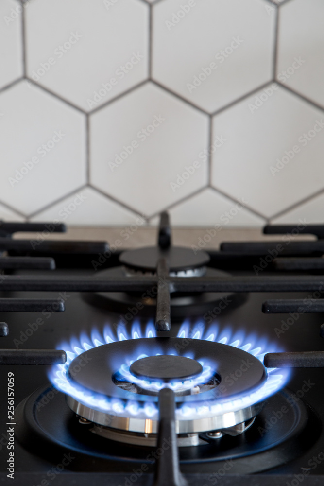 Gas burner on black modern kitchen stove. kitchen gas cooker with ...