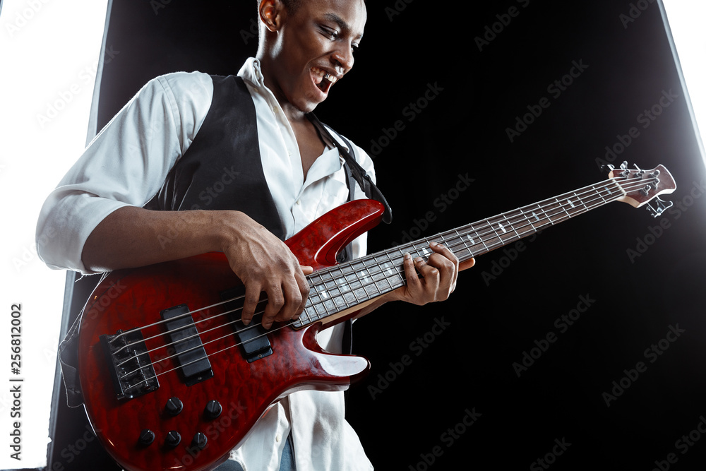 African American handsome jazz musician playing bass guitar in the ...