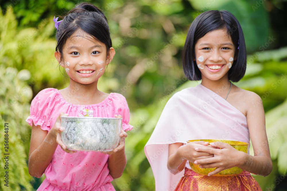 Songkran day with thai girls children playing splash water in songkran ...