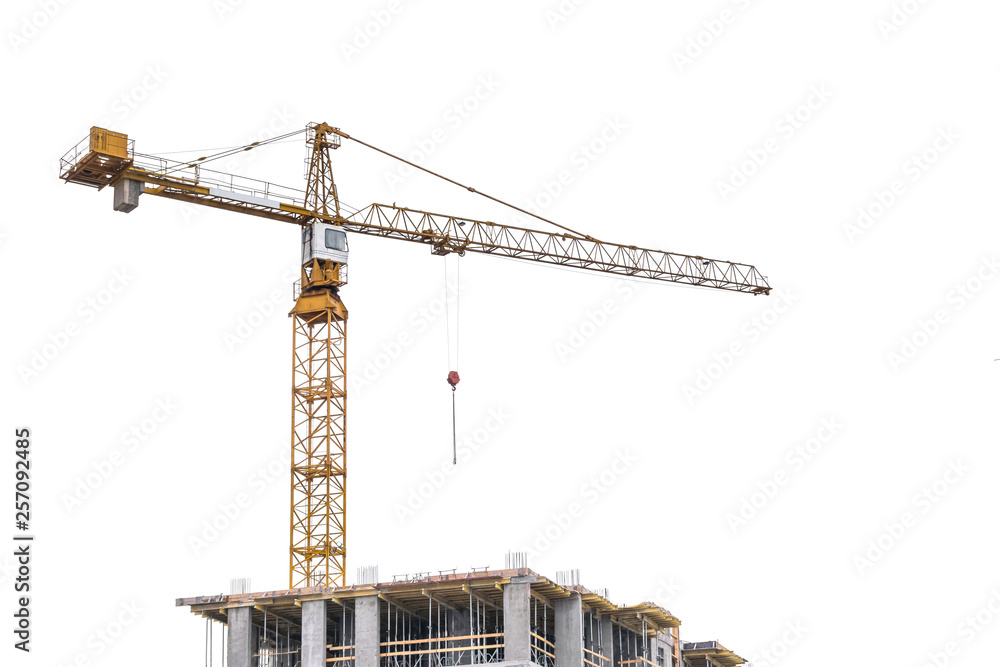 High-rise building crane with a long arrow of yellow color on a white ...