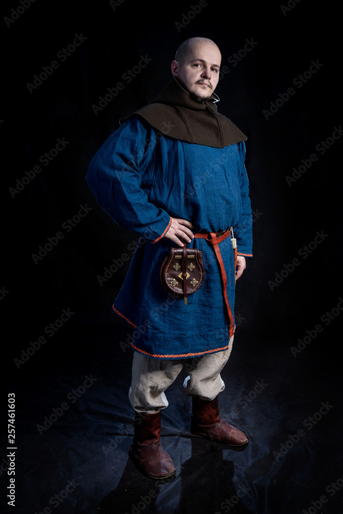 bald man in casual clothes and hood of the viking age Stock Photo ...