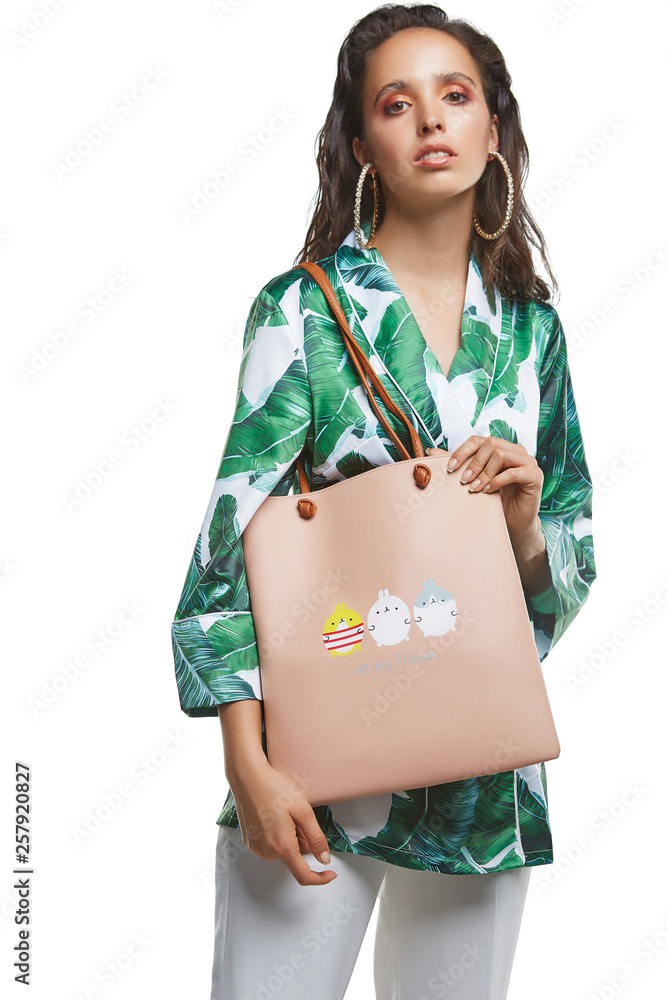 Three quarter front shot of woman, wearing shirt with tropical leaves ...