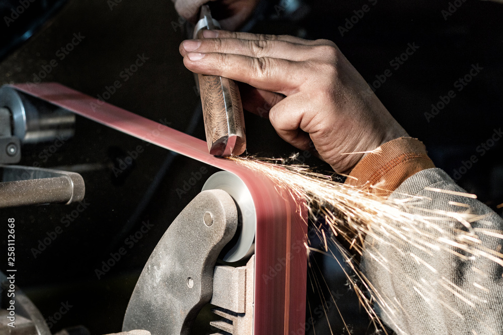 Making knife on the belt grinder with sparks, polishing, sanding handle ...