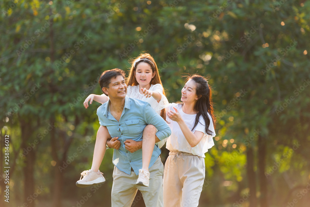 Happy asian playing enjoy funny family time in park with sunlight sky ...