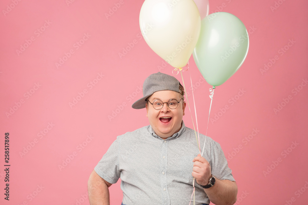 Middle aged happy father dressed in childish style looking at camera ...