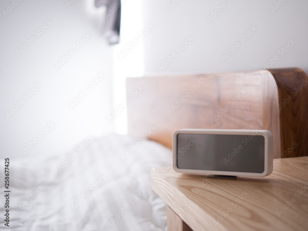 blank displays on digital alarm clock's screen on wood table. Stock ...