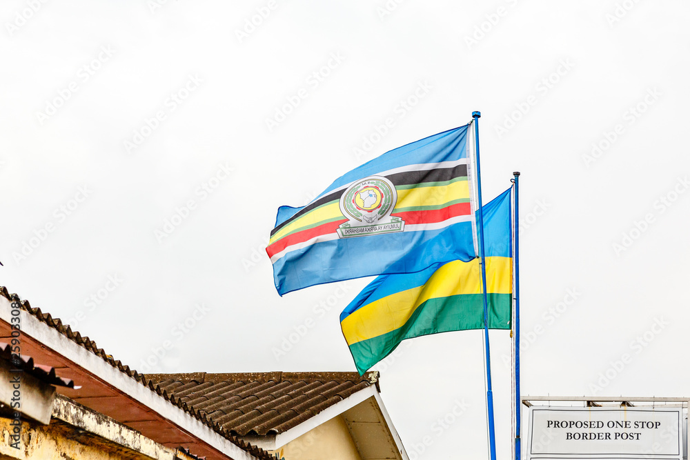East African Community and Rwandan flags on the border between Rwanda ...