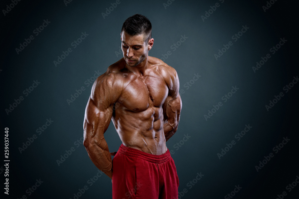 Handsome Body Builder Flexing Muscles Stock Photo | Adobe Stock
