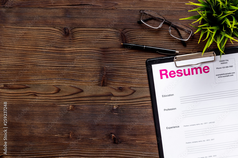 Review resumes of applicants set with glasses wooden work desk ...