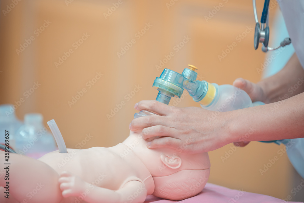 Medical students are training to save lives in the infant model. Stock ...