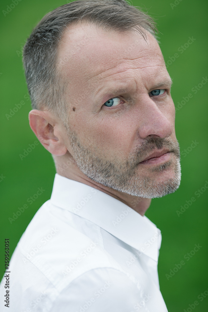 Fabulous at any age. Portrait of 45-year-old man standing over green ...
