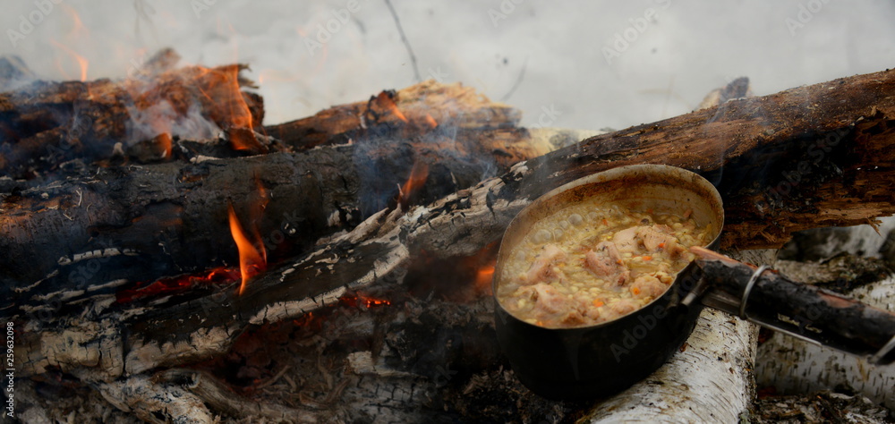 we cook food on a fire in winter Stock Photo | Adobe Stock