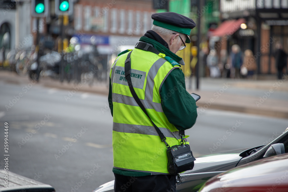 civil enforcement officer or traffic warden with glasses in typical ...