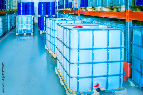 Chemical warehouse. Plastic containers for chemicals are placed on the ...