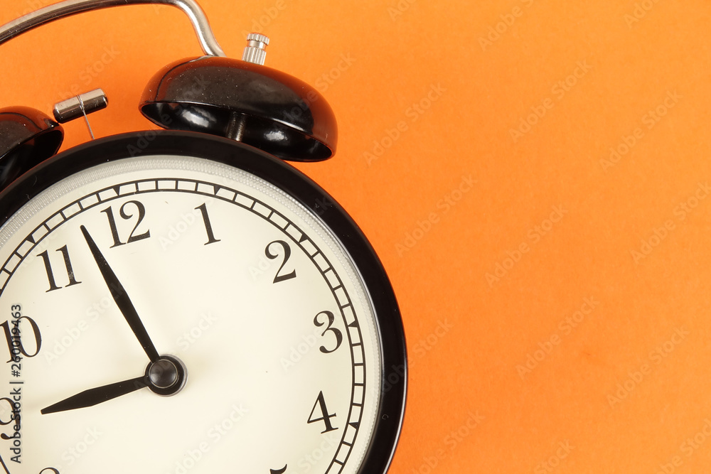 Time Punctuality Concept with black alarm clock. Stock Photo | Adobe Stock