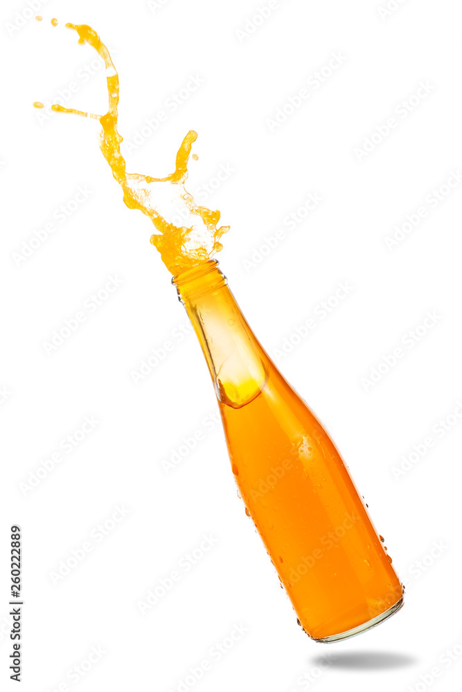 Orange juice splashing out of bottle isolated on white background ...
