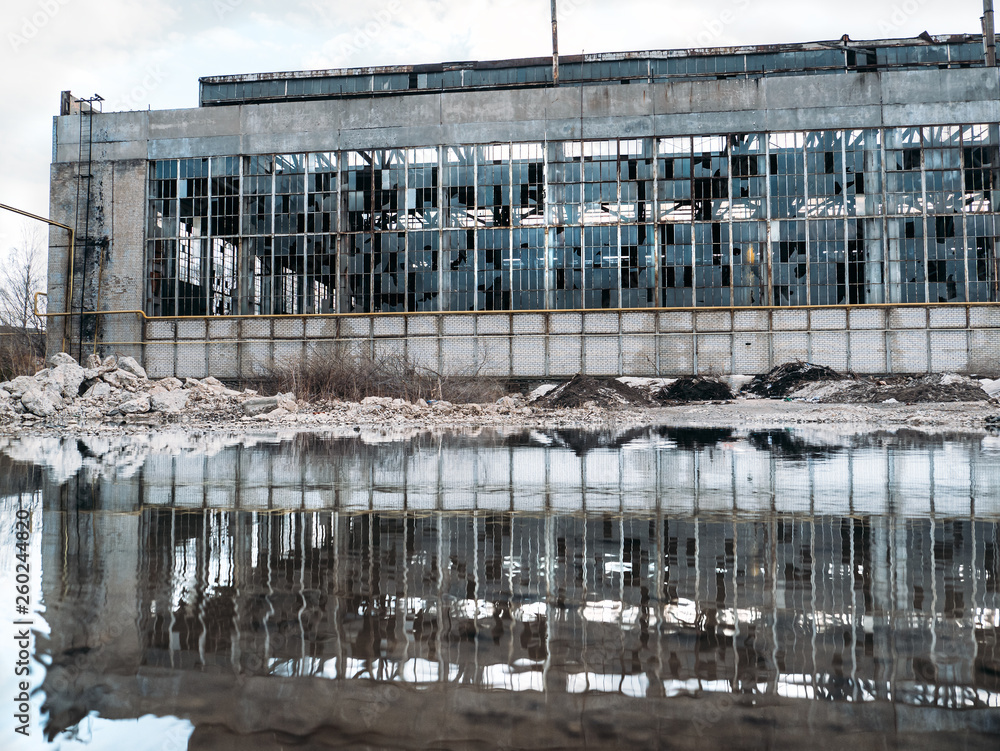 Flooded territory of abandoned ruined industrial factory building with ...