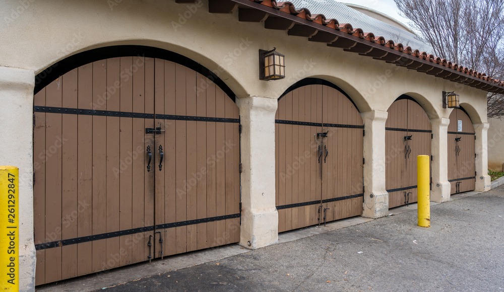 Wood doors entrance in a row, spanish style architecture, horse stable ...