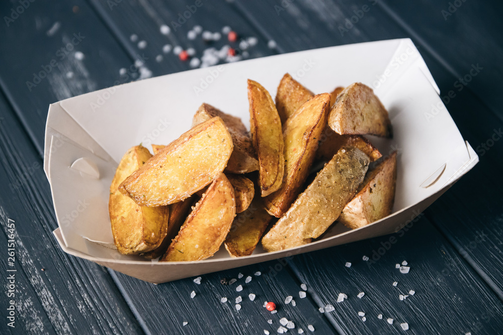 Baked potatoes.Snack in paper eco-friendly boxes. Takeout food in a ...