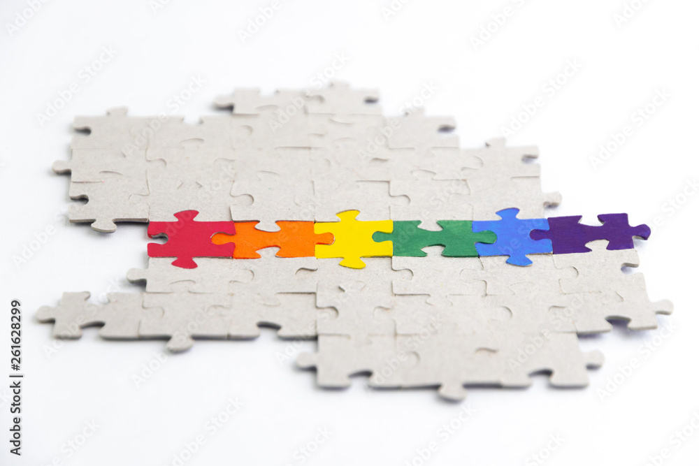 LGBT pride flag, built from a puzzle, among gray puzzles, short focus ...