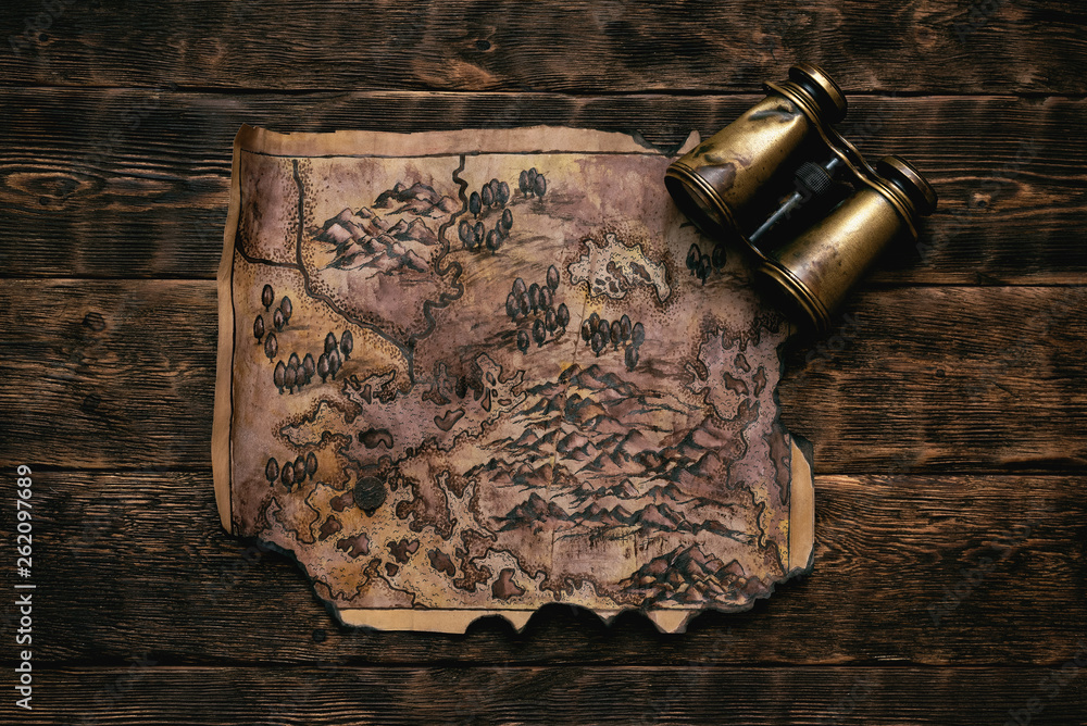 Old map and binoculars on a adventurer table background. Treasure hunt ...
