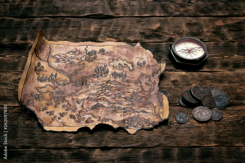 Old map and compass on a adventurer table background. Treasure hunt ...