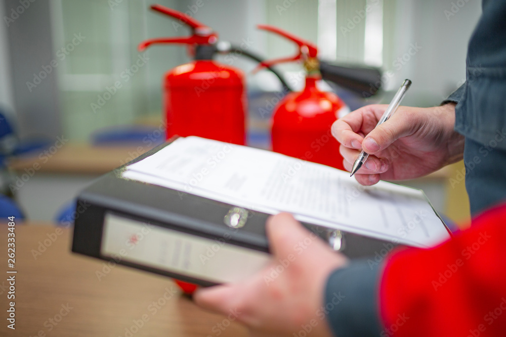 Engineer Professional are Checking A Fire Extinguisher Using Clipboard ...