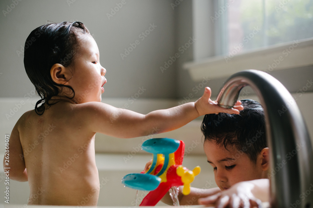 Kids playing in bath Stock Photo | Adobe Stock