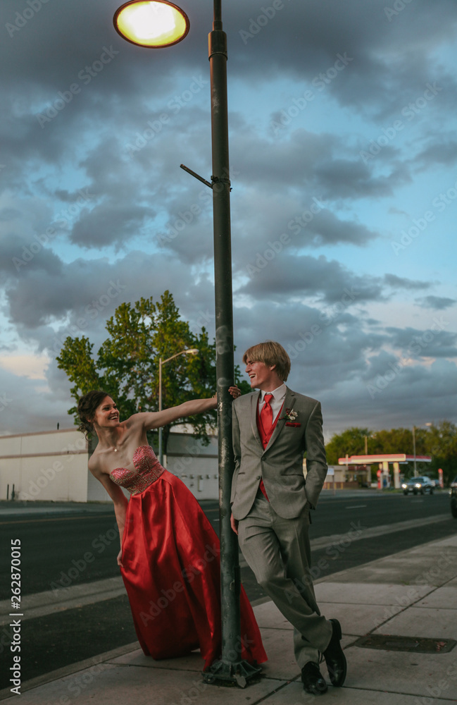 teenage couple dressed up for high school prom having fun before the ...