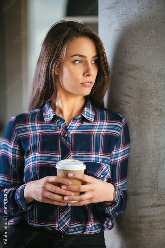 Attractive business woman drinking coffee in her office. Pretty young ...