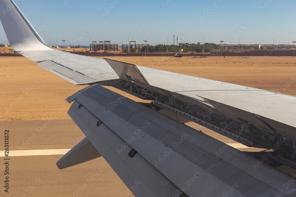 The plane lands on the airfield. Spoilers and flaps trailing edge when ...