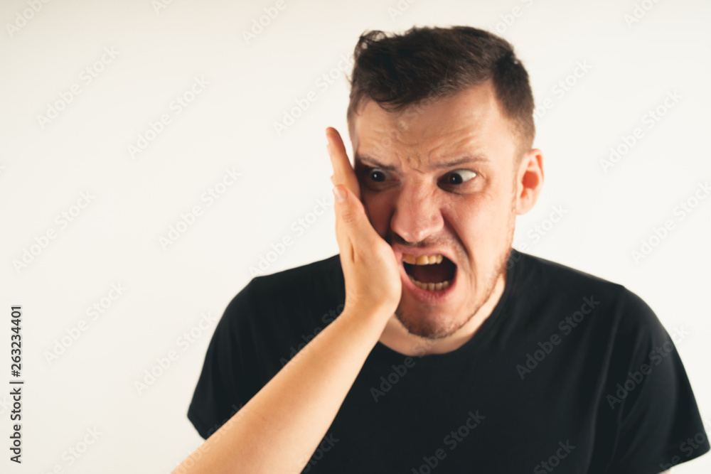 Crop person slapping scared man in face. Emotional male getting slapped ...