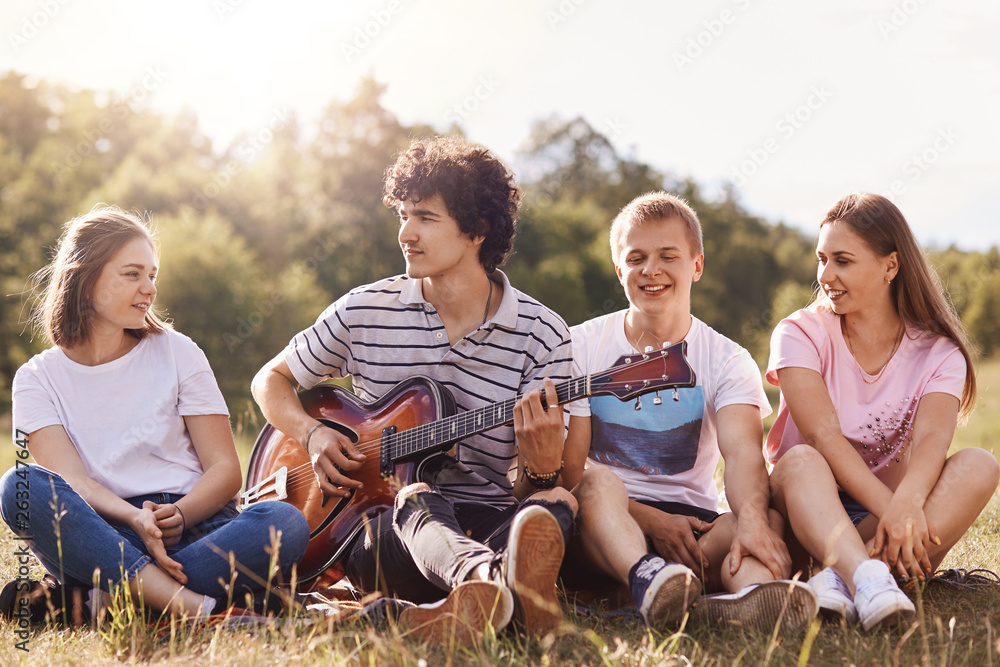 Friends enjoying singing songs, spending time together, have good mood ...