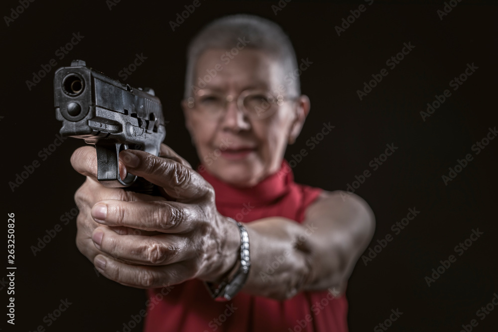Classy undercover agent, a senior old woman aiming a gun, policewoman ...