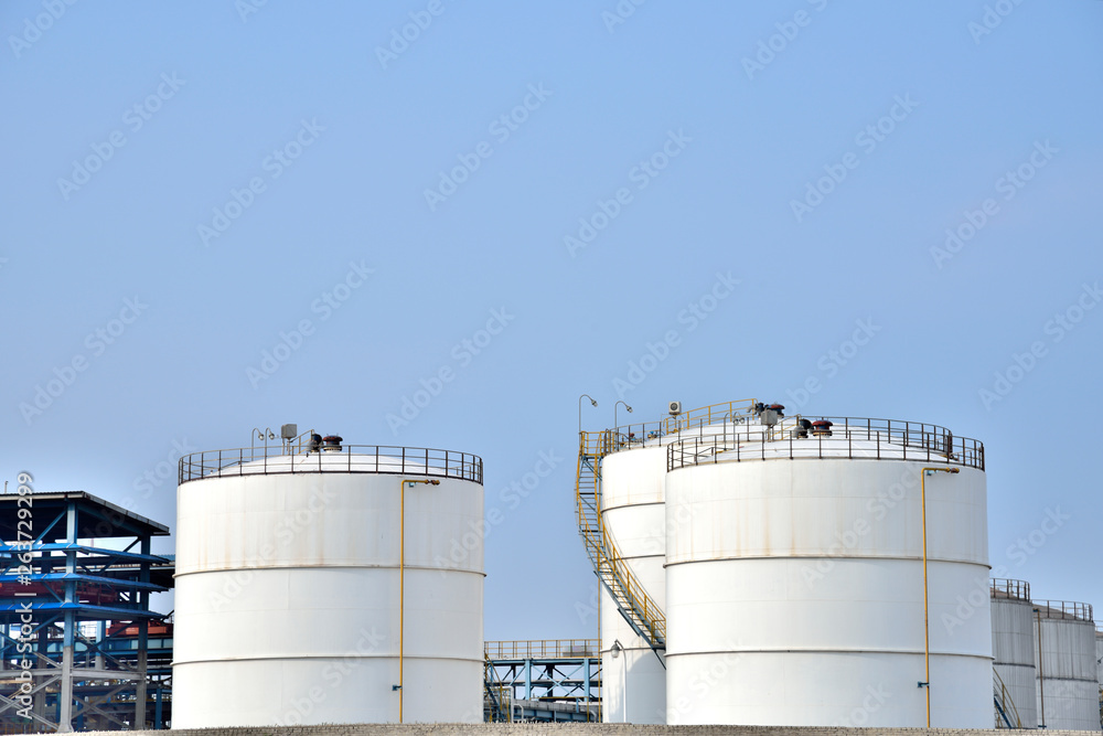 Big white gasoline and oil industry of storage tanks in the blue sky ...